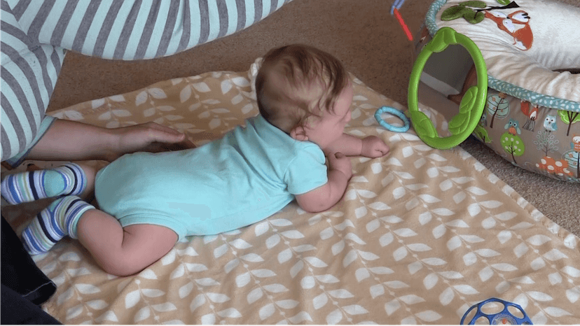 Pathways.org | While lying on tummy, supports self on arms