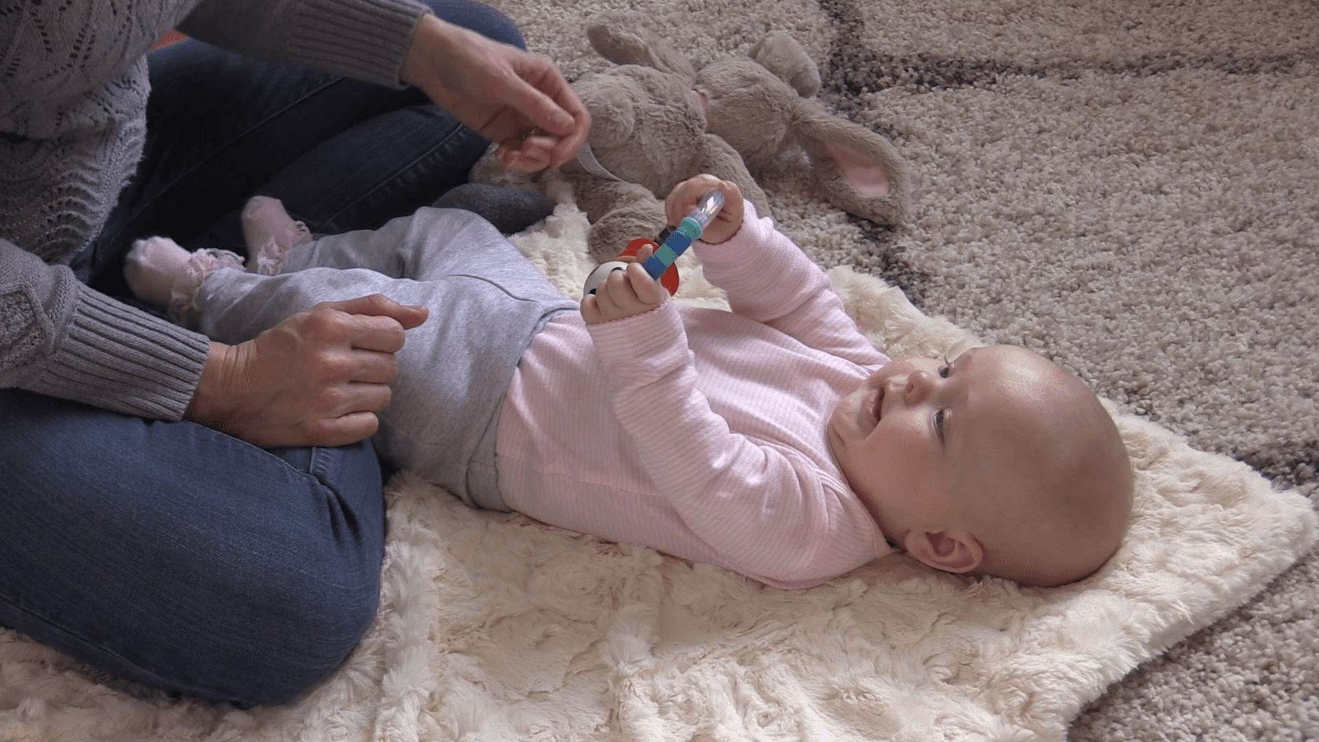 Pathways.org | Uses both hands to explore toys